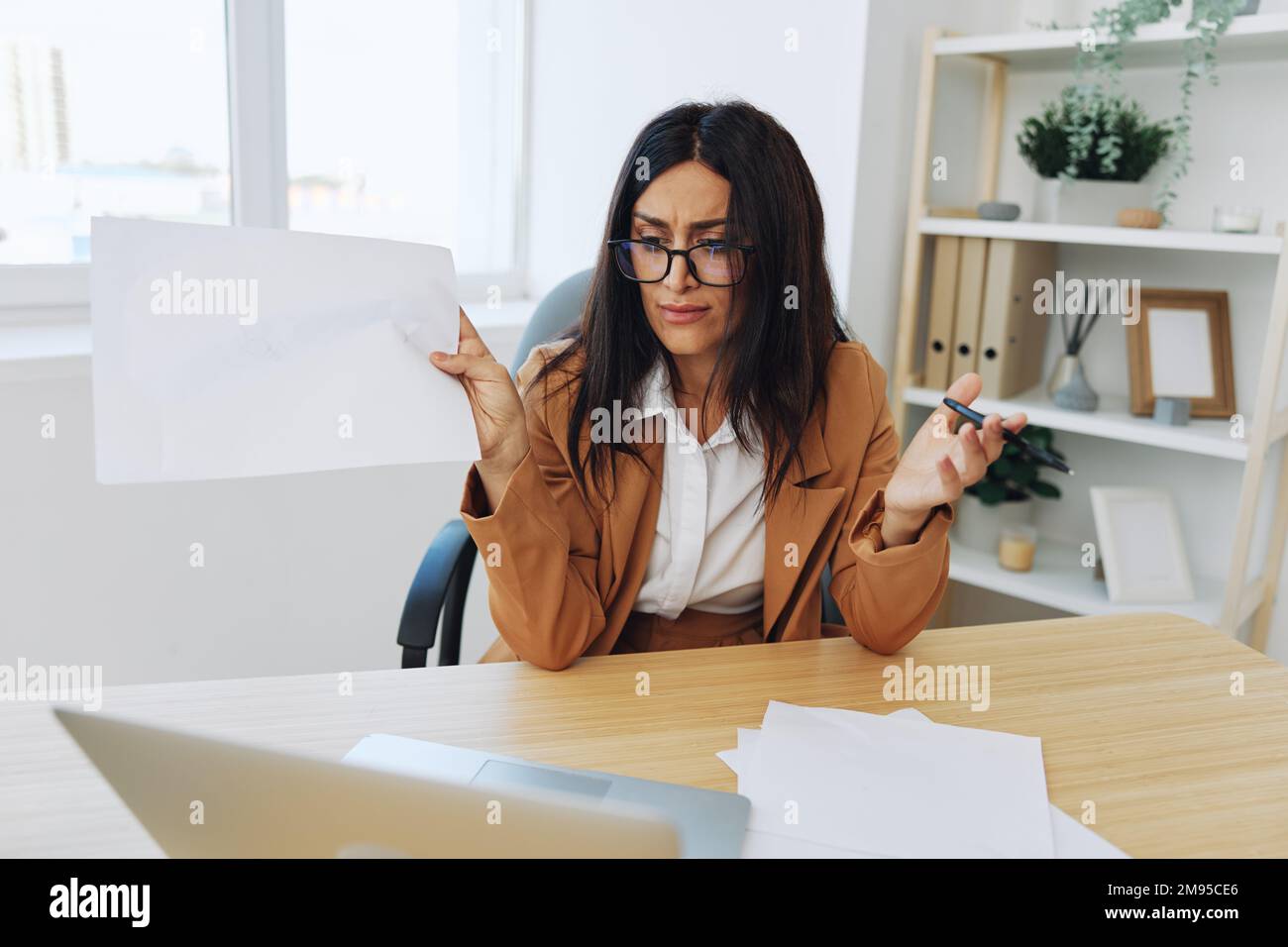 Business woman working in office at desk with laptop, anger and ...
