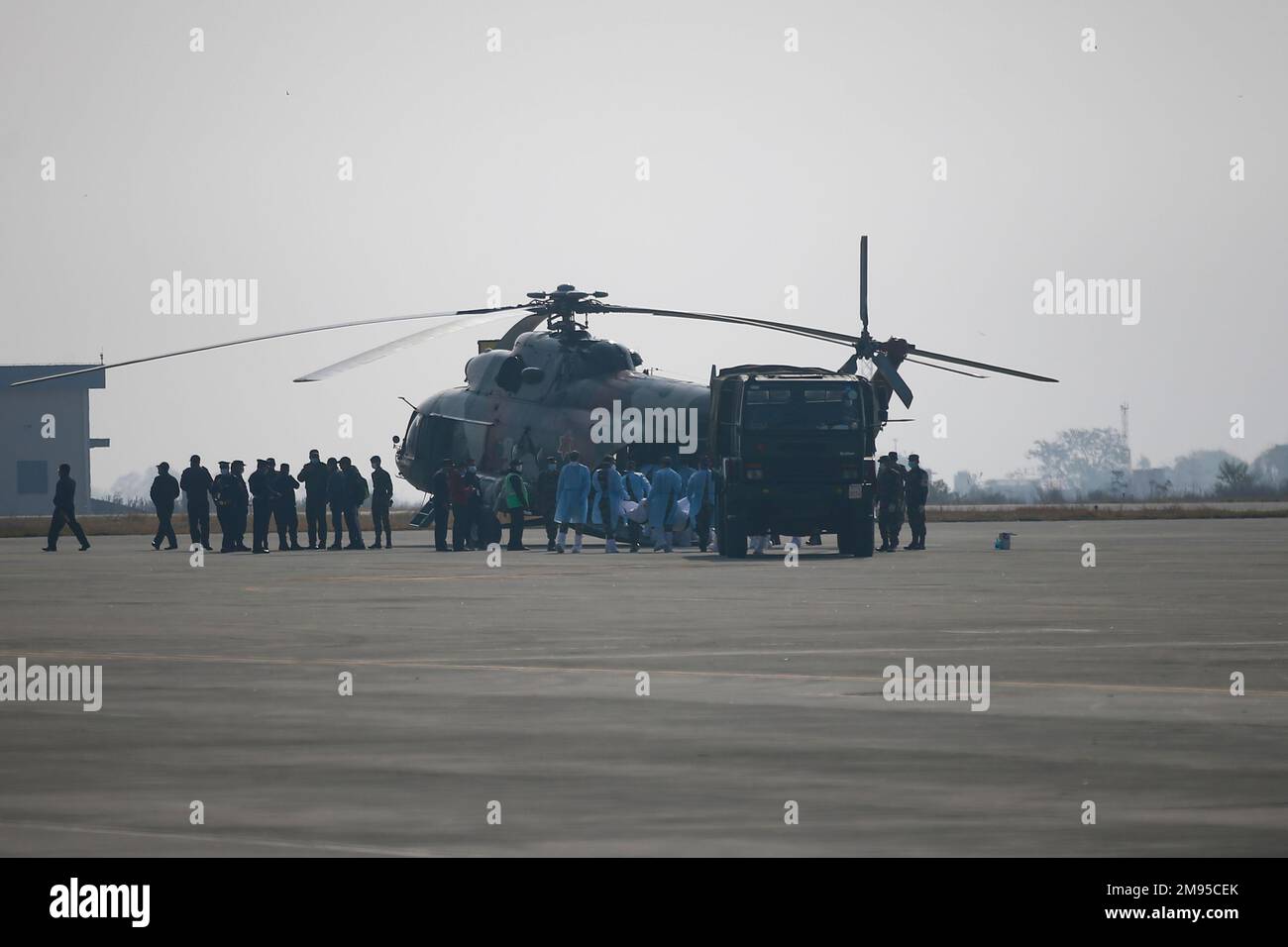 Pokhara, Nepal. 17th Jan, 2023. Members of the Nepali Army load bodies ...