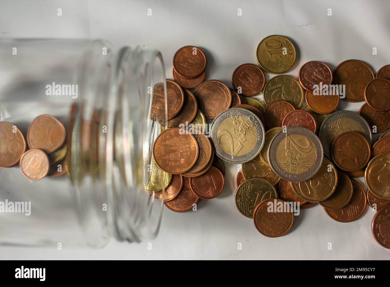 saving euro coins when the prices are high Stock Photo - Alamy