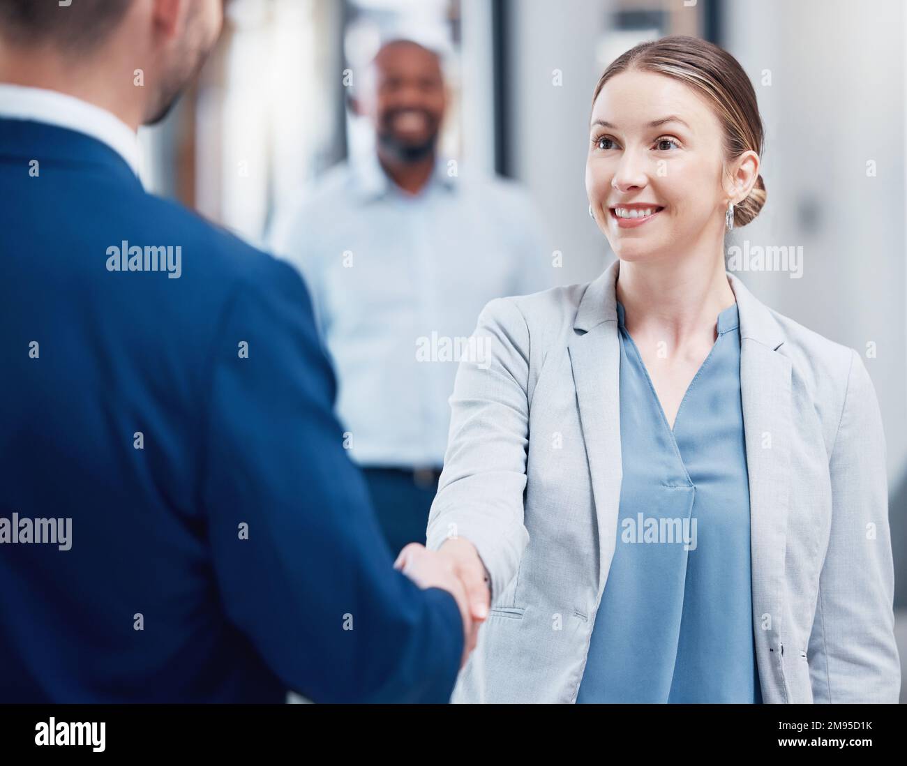 Giving you a warm welcome. two businesspeople shaking hands in an ...