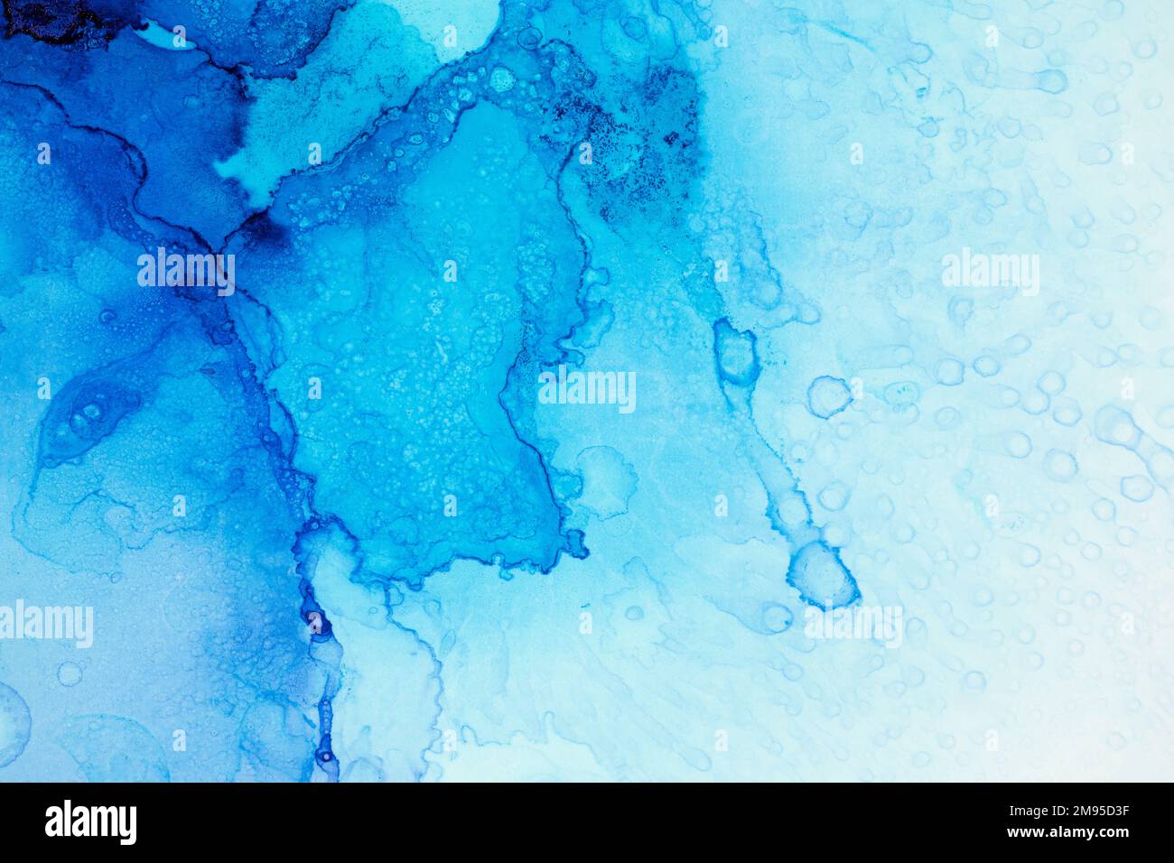 Abstract bright blue alcohol ink paint drops and splotches on white ...