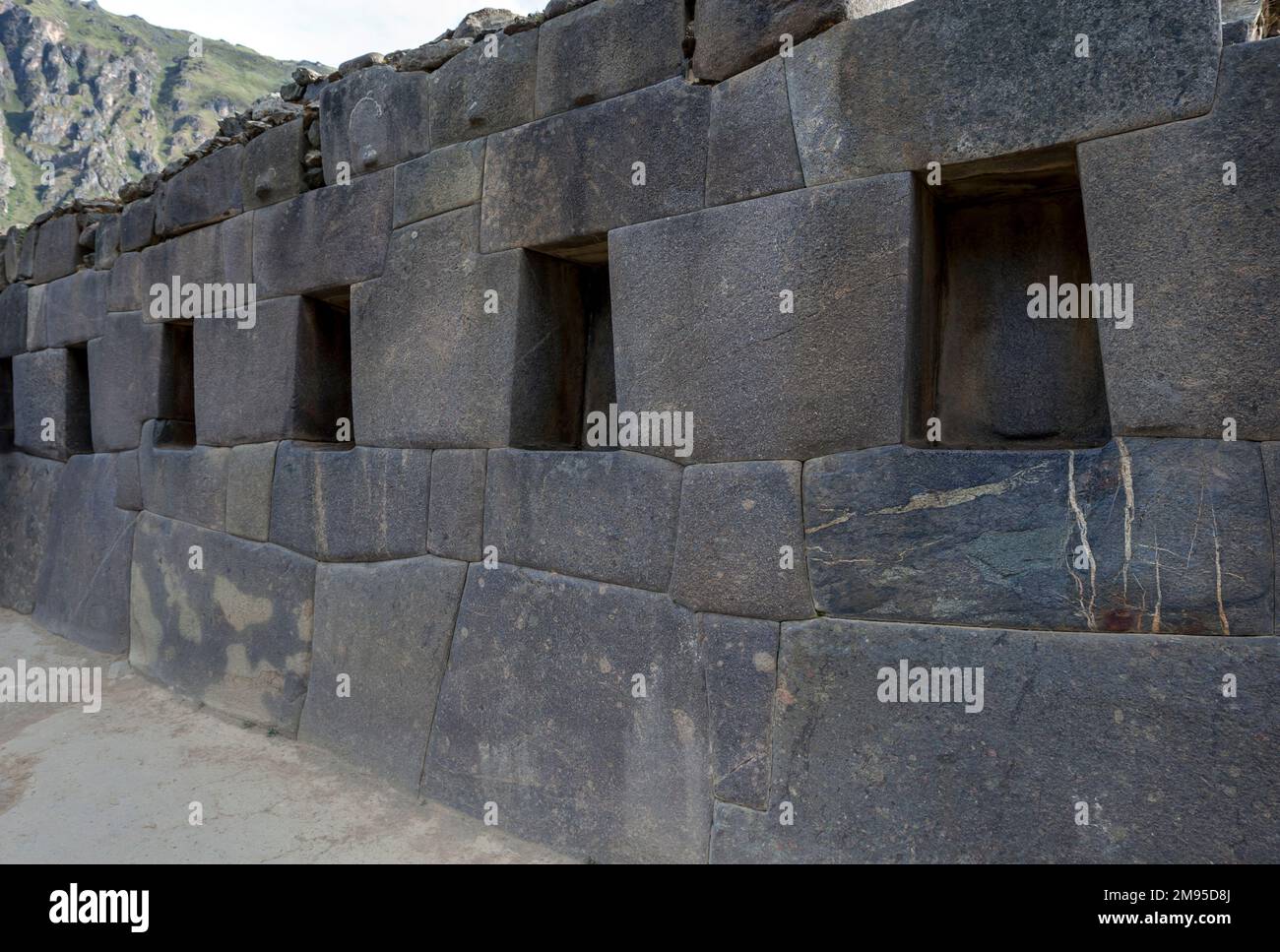 A section of a carved interlocking stone wall at the ancient site of ...
