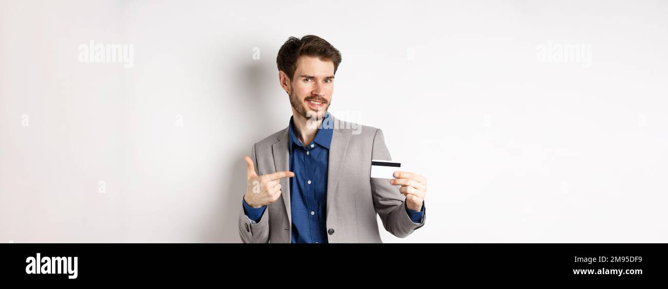 Successful male entrepreneur pointing at plastic credit card and ...