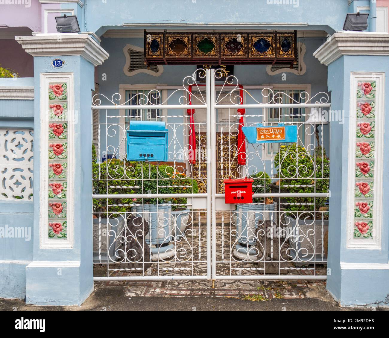 Letterboxes on a gate in front of Peranakan Shophouse on Kooon Seng Rd ...