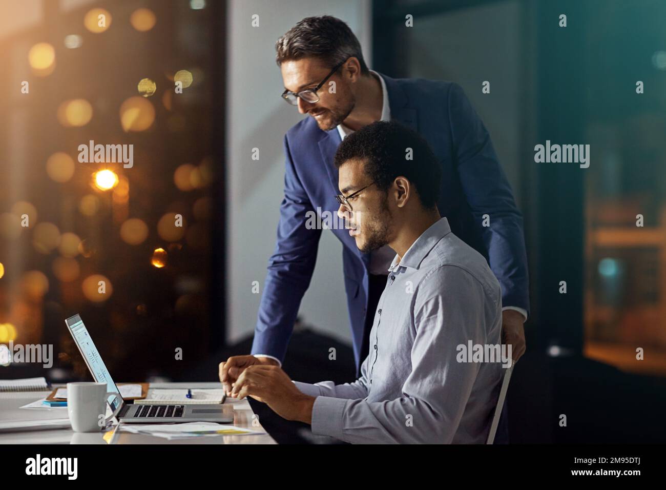 Team, laptop and collaboration working at night in office for business ...