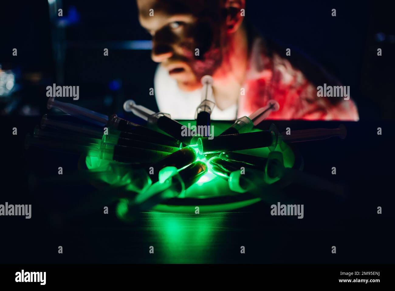 syringes with blood for Halloween and a scary man in makeup with ...