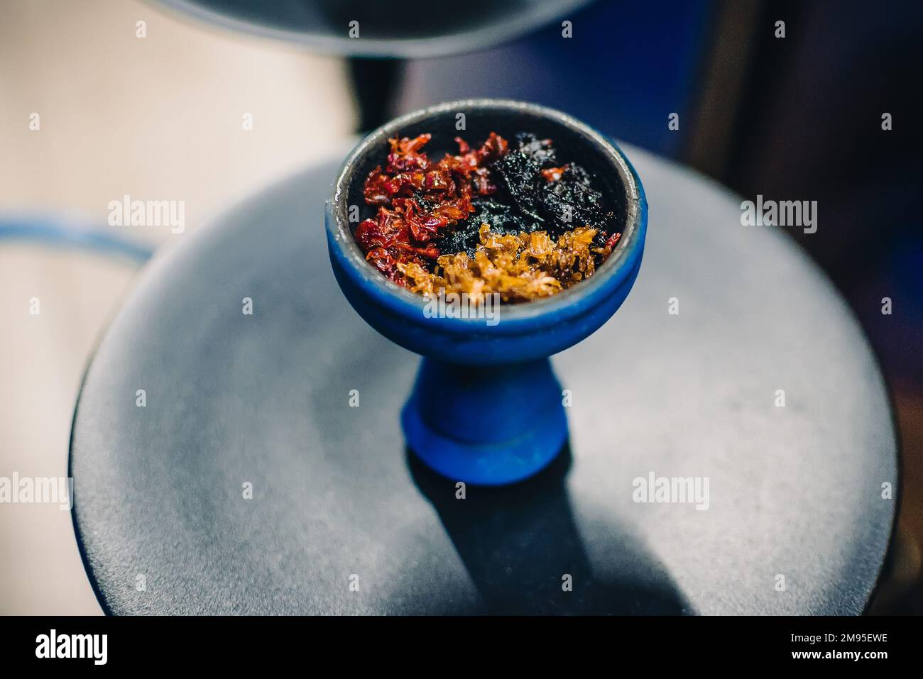 bowl of the hookah is filled with tobacco mixed with different flavors ...