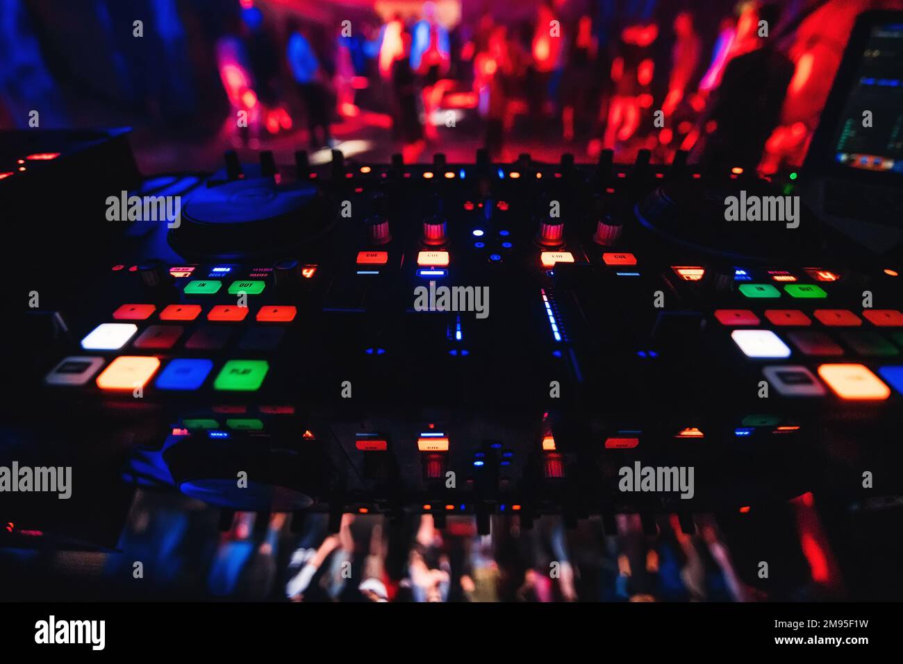 mixer DJ at a nightclub with controls and buttons for mixing music at a ...