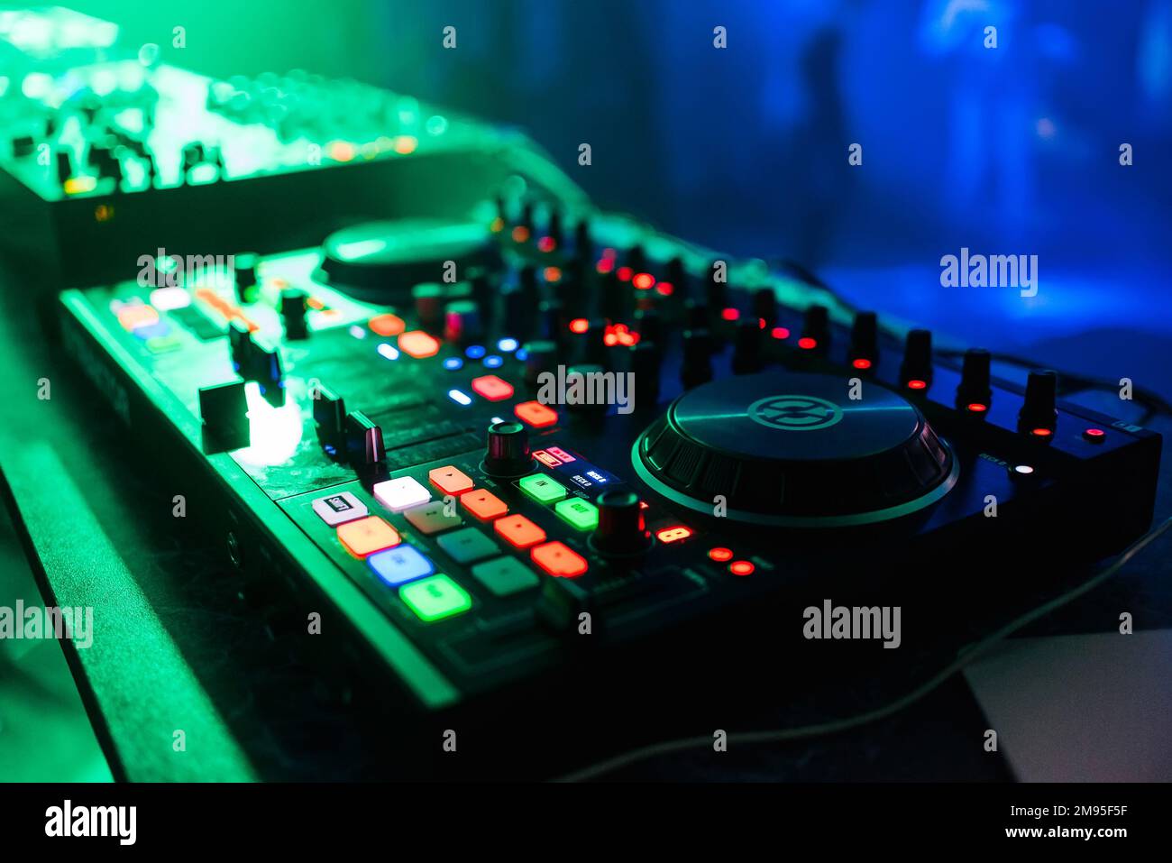 professional control panel and mixing music under the green lights in ...