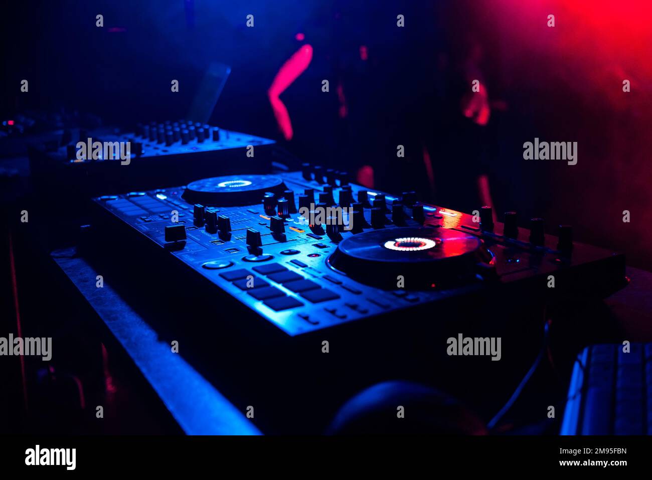 music mixer controller music control DJ under the light of spotlights ...