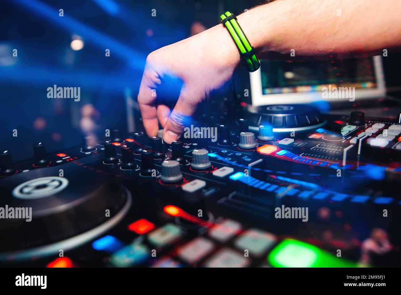 professional panel DJ mixer with hand controlling mixing music in ...