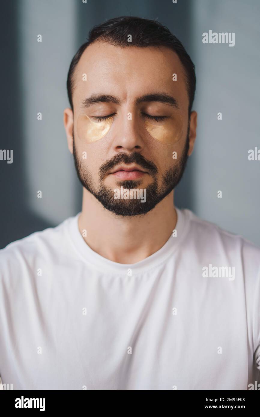 Calm Caucasian man with eye patches relieving negative emotions. Rest ...