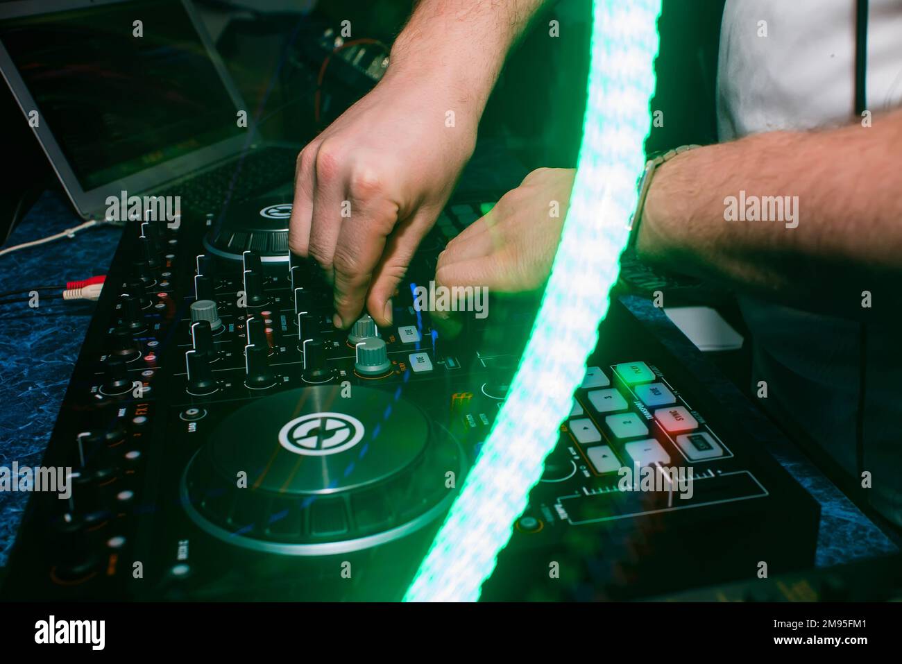 hands of the DJ booth playing the music and mixer in nightclub with ...