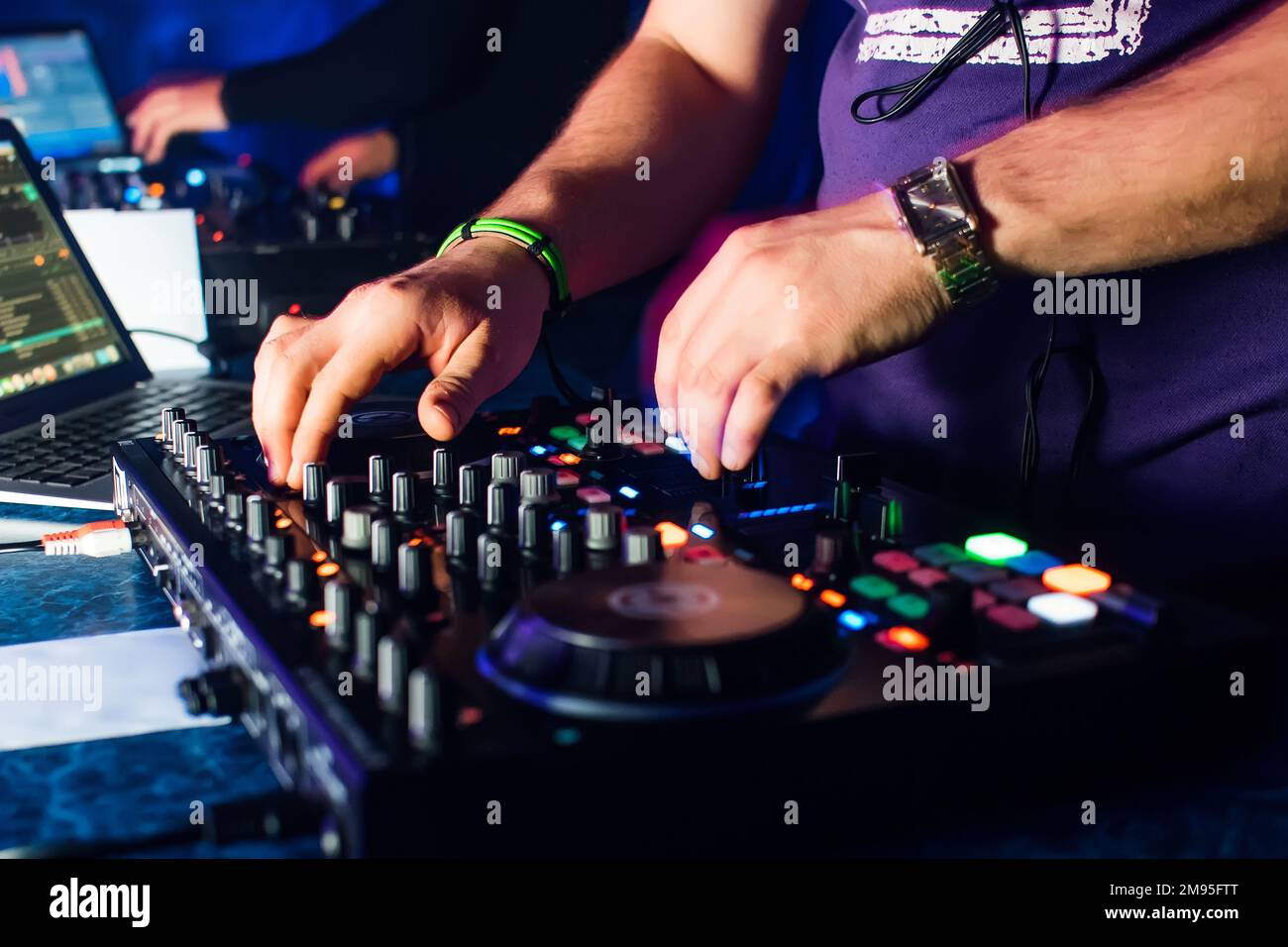 hands of the DJs playing on the professional Board and mixer with ...