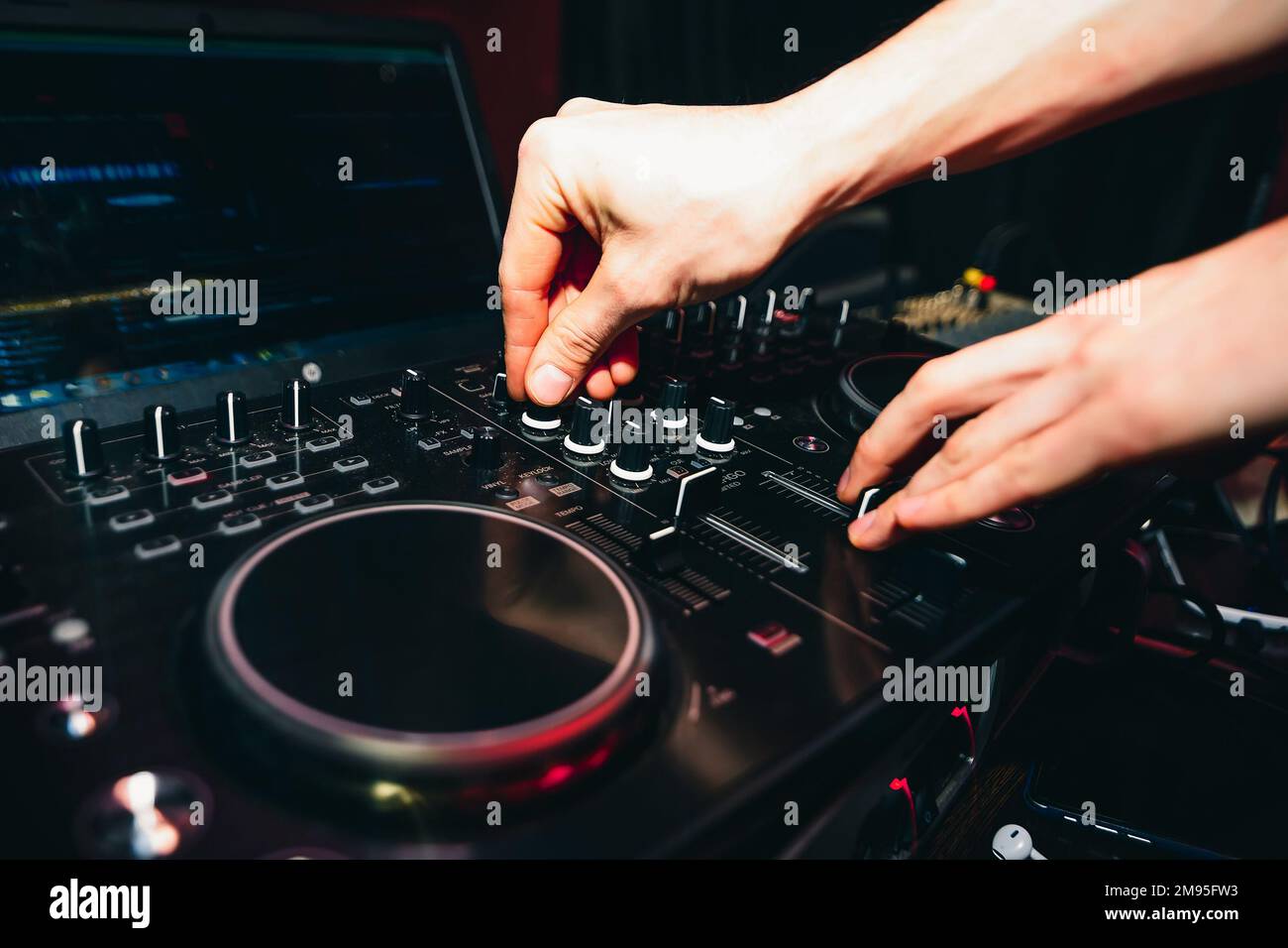 hands of DJ controllers for music on a professional mixer for mixing ...