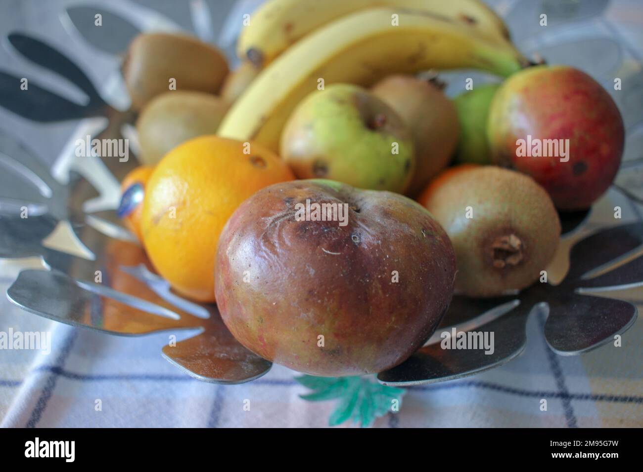 rotten apple among other fruits in the fruit bowl Stock Photo - Alamy