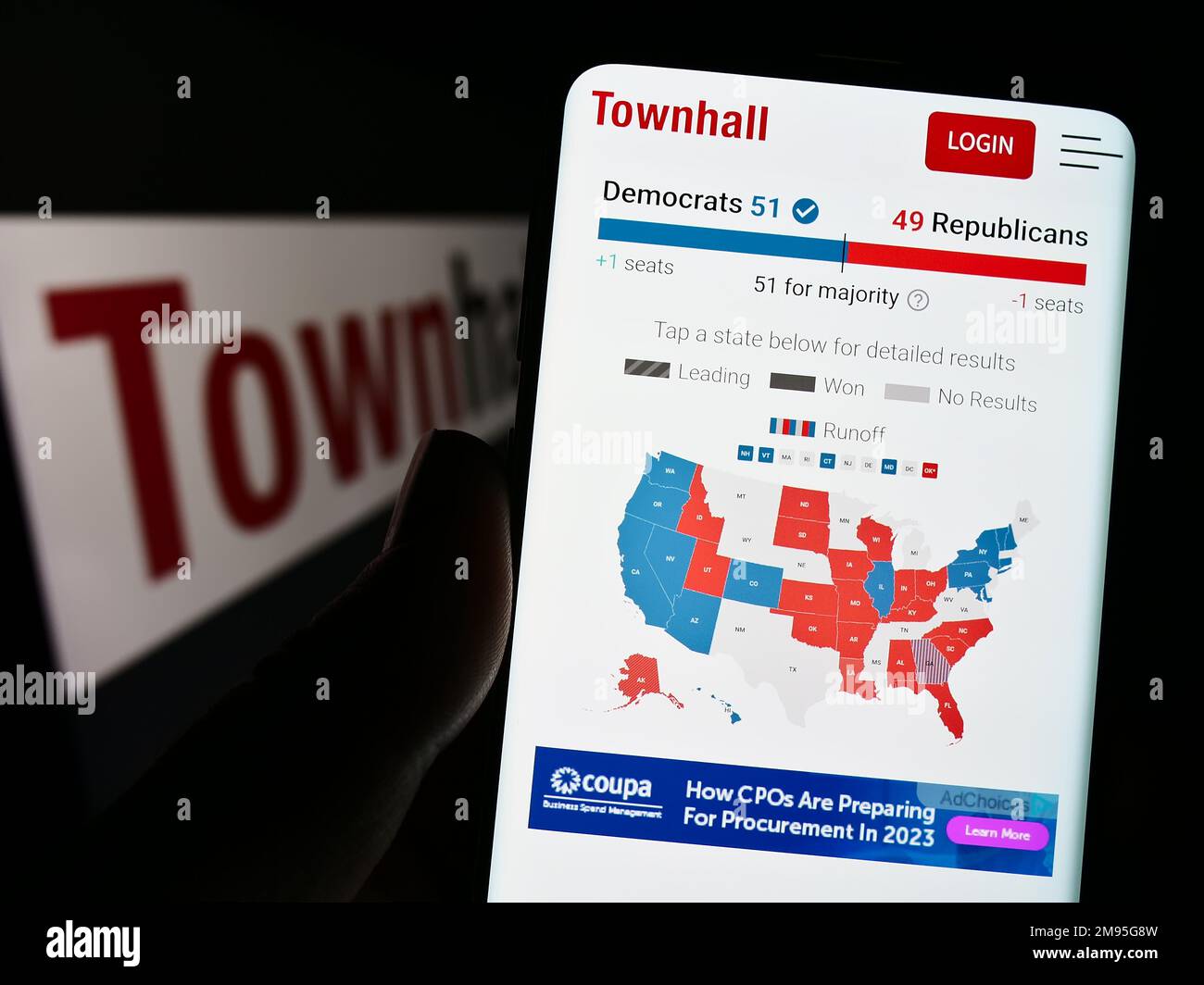 Person holding cellphone with webpage of US conservative news website ...