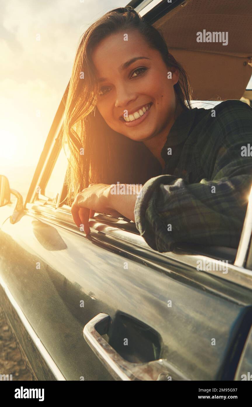 Portrait, driver and road trip with a black woman in a car at sunset ...