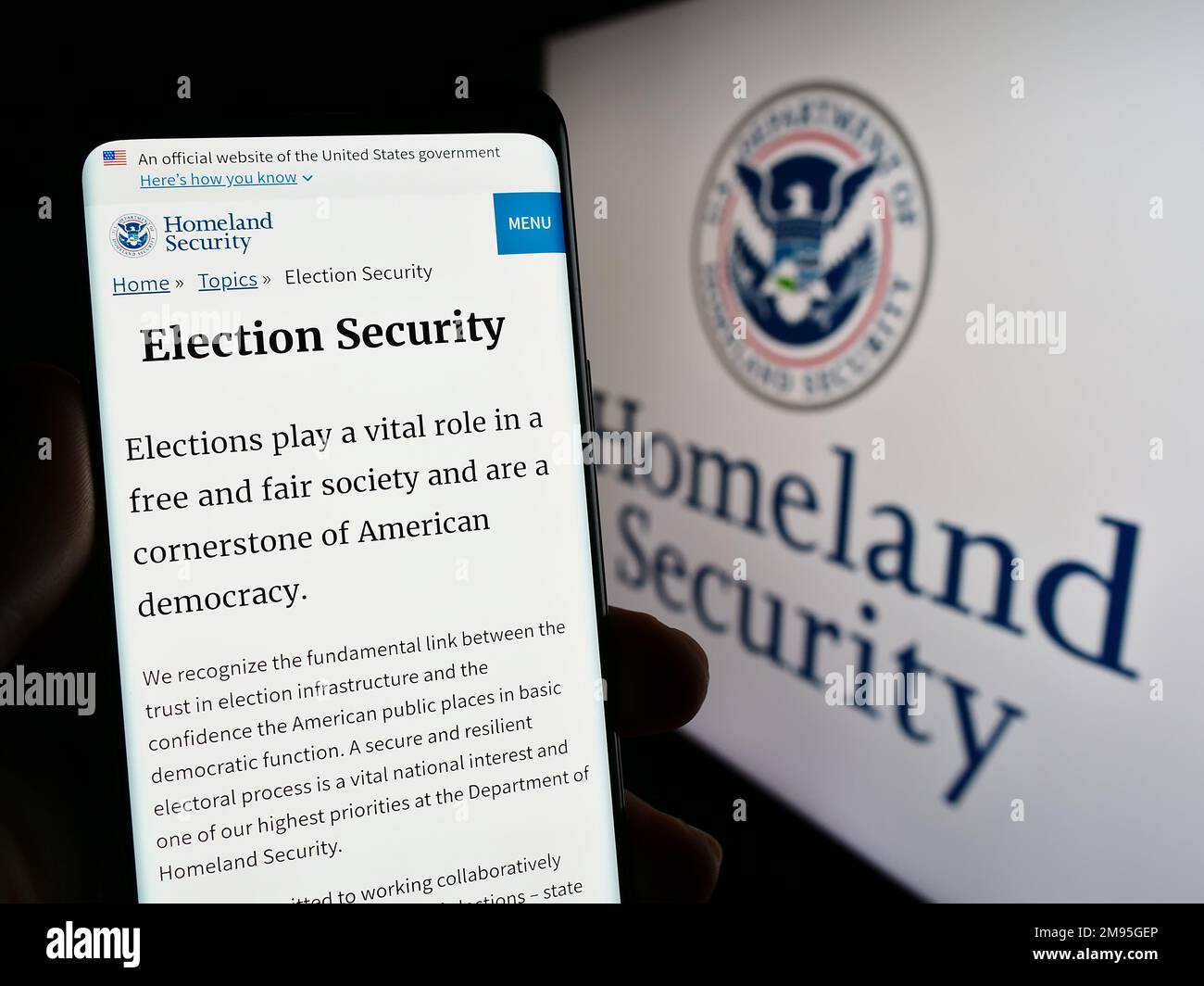 Person holding smartphone with web page of US Department of Homeland ...