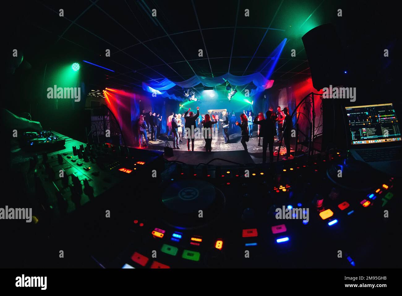 night club with dancing people on the dance floor and stage for musical ...