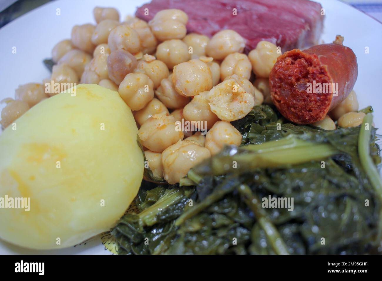 cooked pork legs with potatoes and chickpeas, typical dish from Spain ...