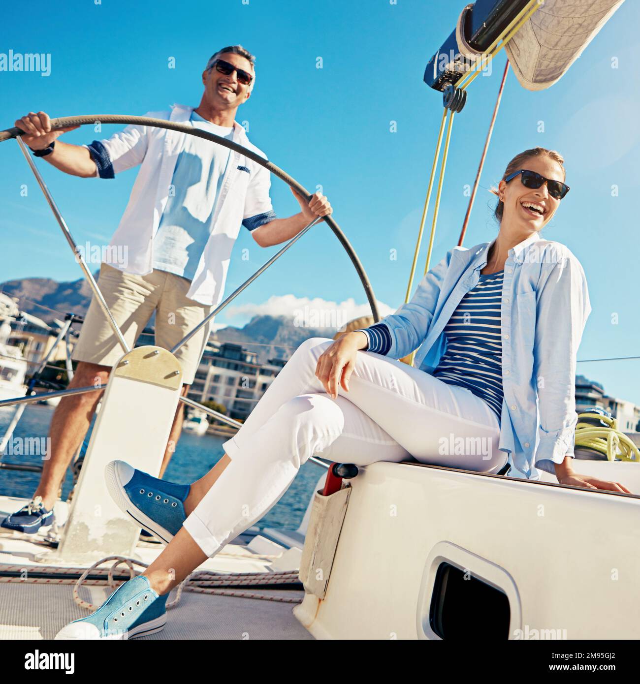 Yacht, travel and love with a couple at sea sitting on a boat together ...