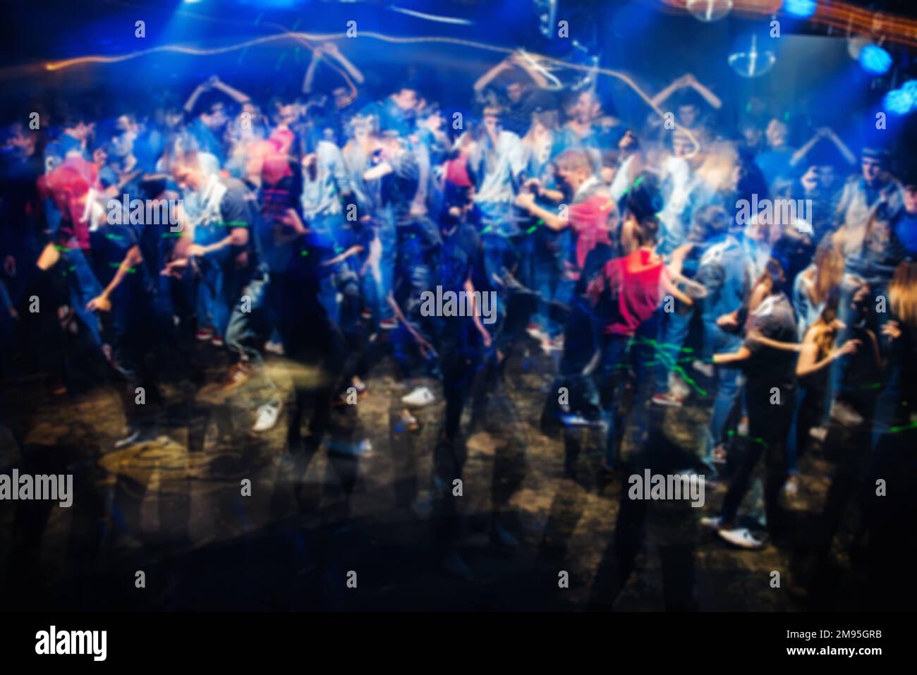 blurred abstract silhouettes of dancing people in night club with ...