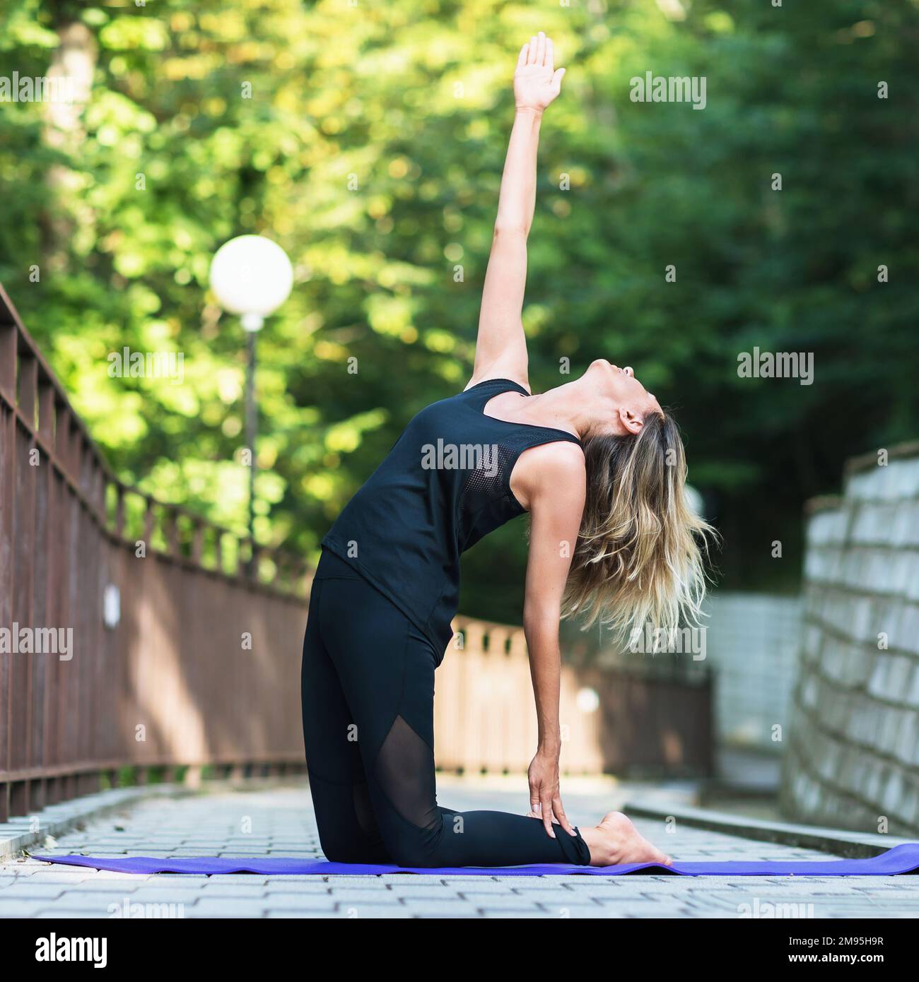Woman leading a healthy lifestyle and practicing yoga, performs a ...