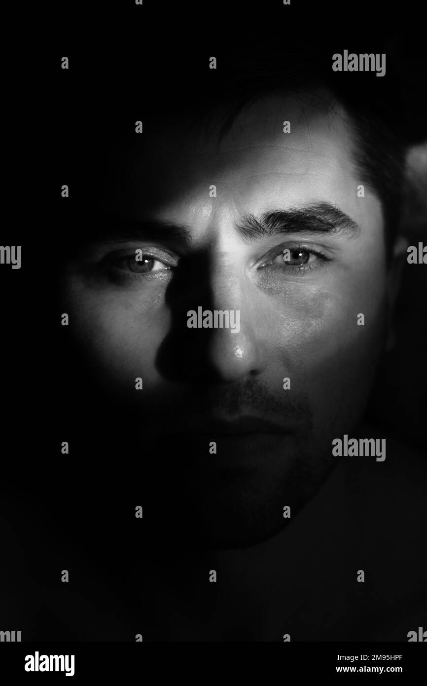 Monochrome portrait of a man with light from the window, portrait of a ...