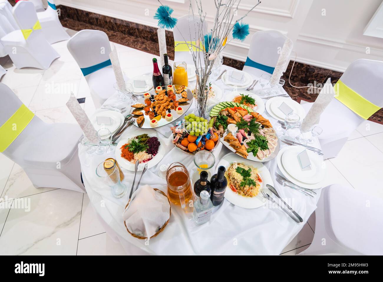 festive chic white table with food and drinks for the gala dinner in ...