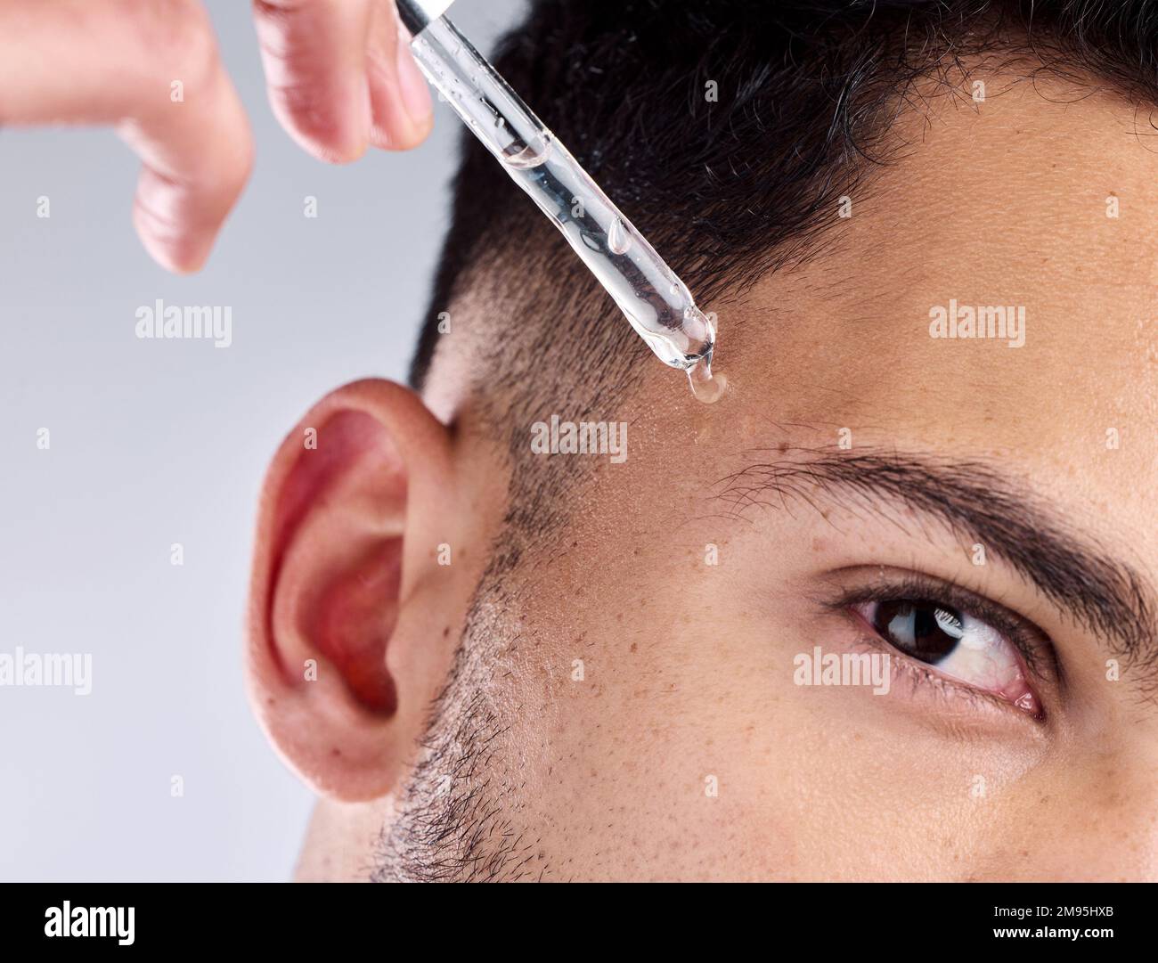 Watch me get ready for the day. a handsome young man applying serum to ...