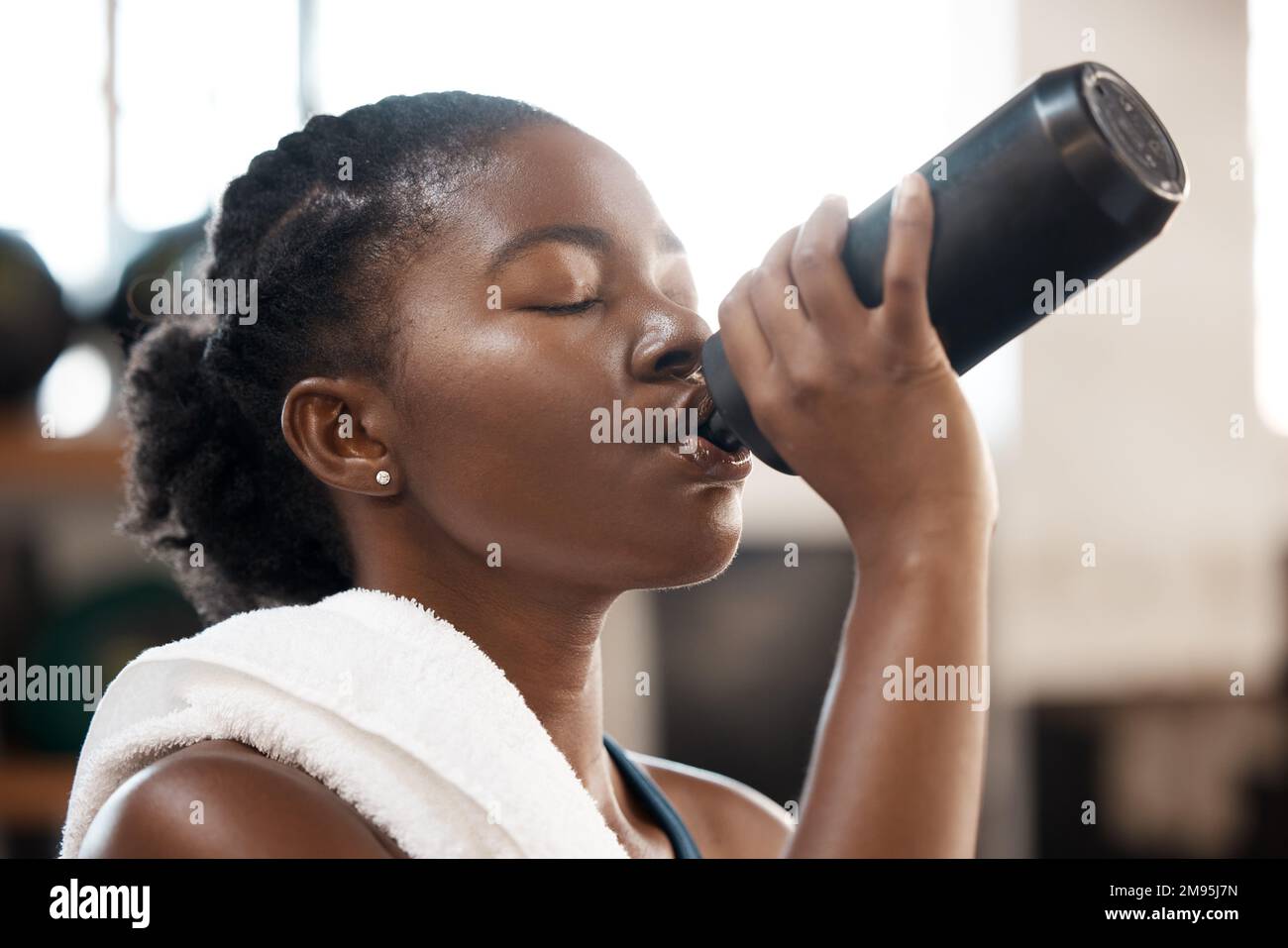 This will cool me right down. a sporty young woman drinking water while ...