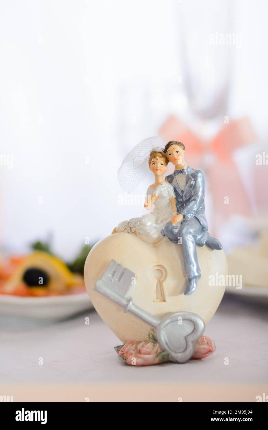 figures embracing bride and groom Stock Photo - Alamy