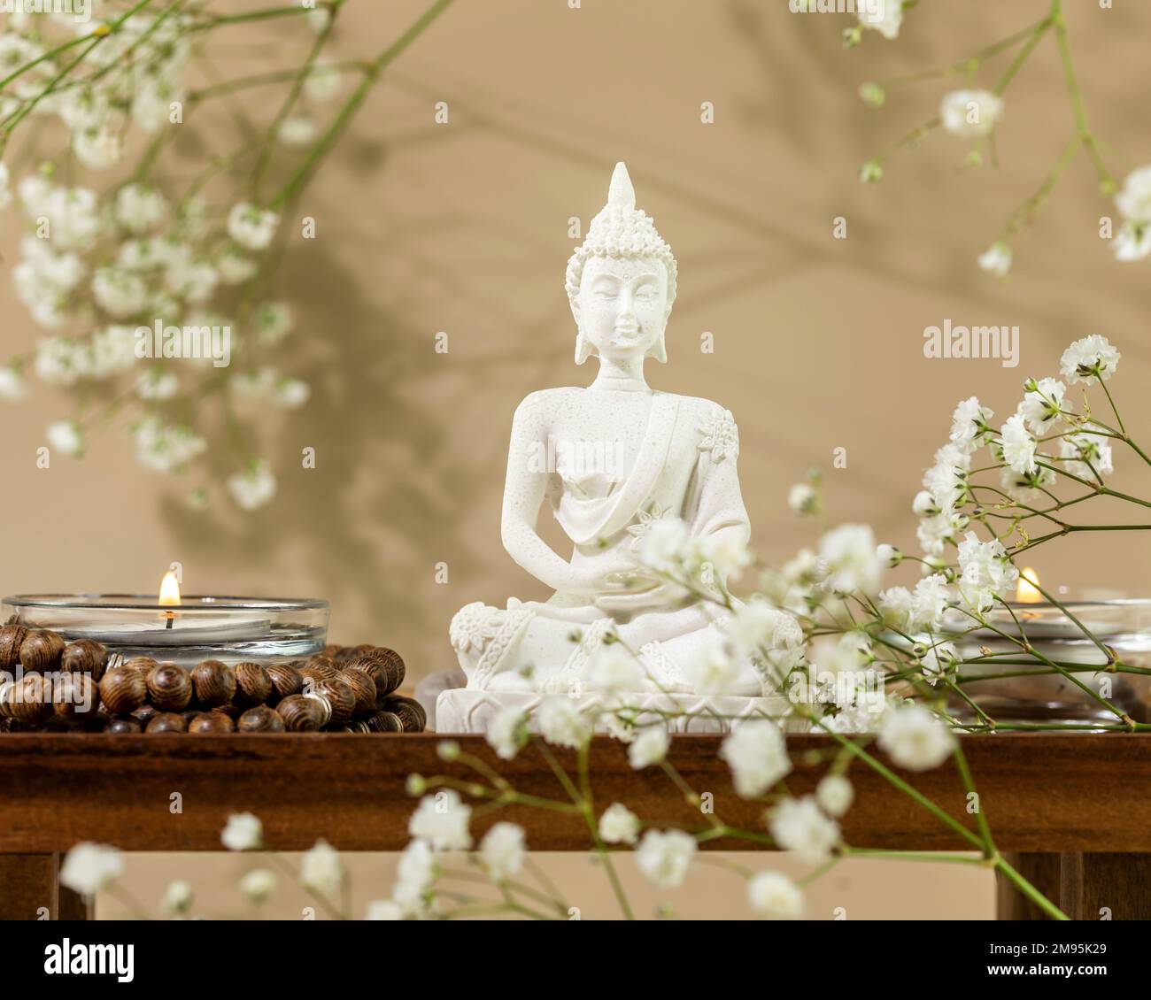 Vesak, Buddha Day holiday. Buddha statue and candles on wooden podium ...