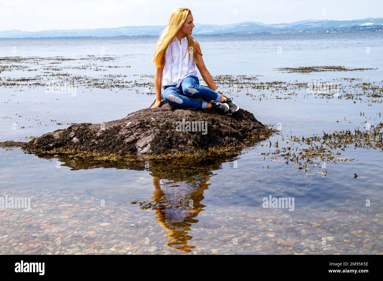 Rhianna Martin, a beautiful blonde sitting on a rock in the River Tay ...