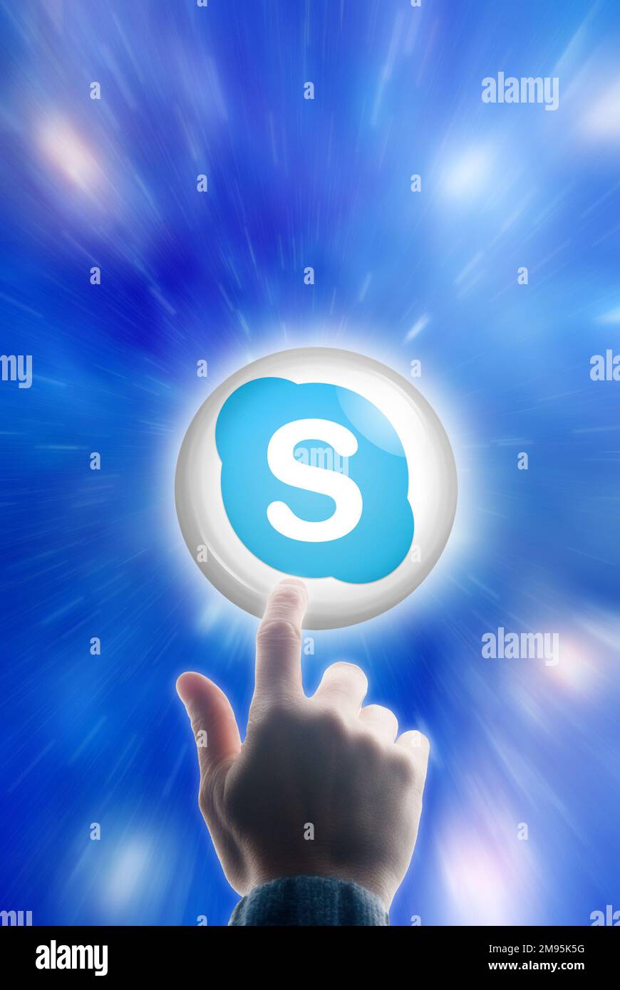 man finger touching a button with logo of Skype Stock Photo - Alamy