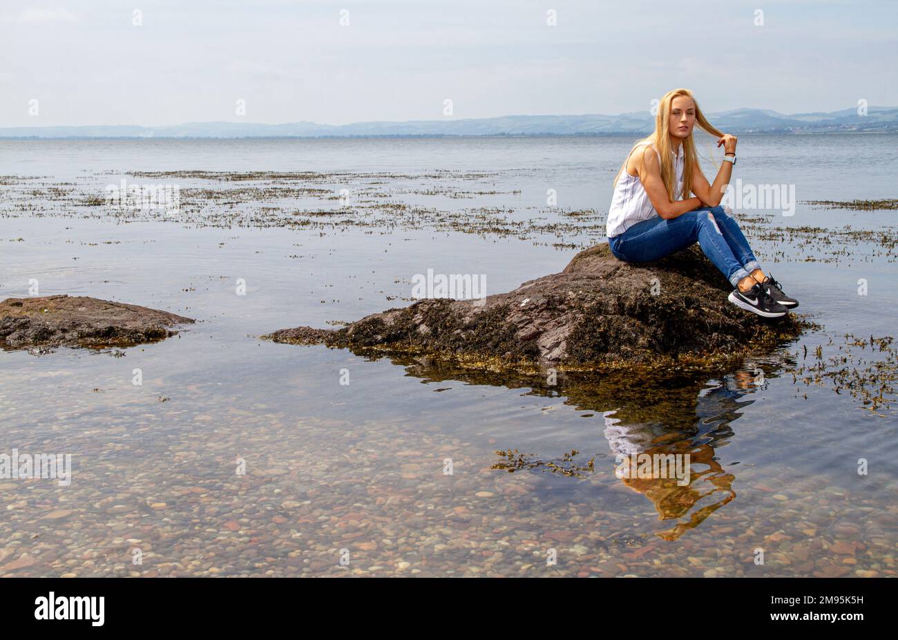 Woman on a rock in water scotland hi-res stock photography and images ...