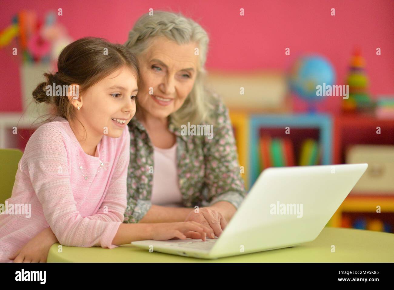 portrait of happy grandmother and daughter using laptop Stock Photo - Alamy