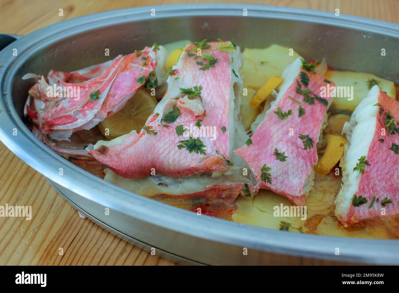cooking tasty red bream with potatoes at home Stock Photo - Alamy