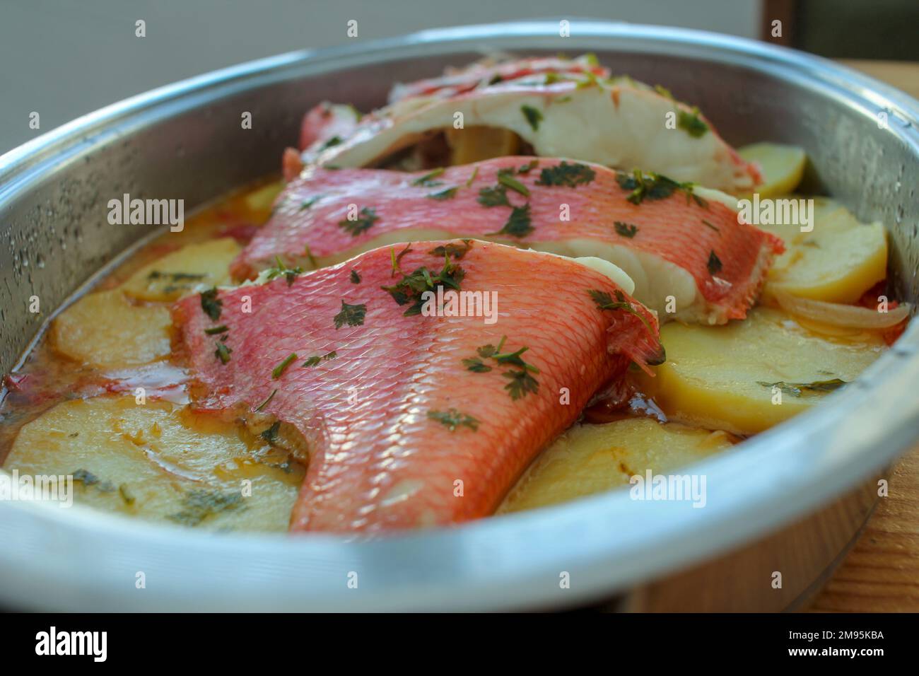 the pleasure of cooking red bream with potatoes for lunch Stock Photo ...