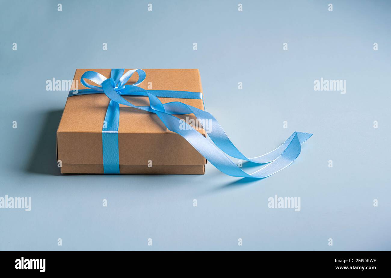 Stylish gift box on a blue background Stock Photo - Alamy