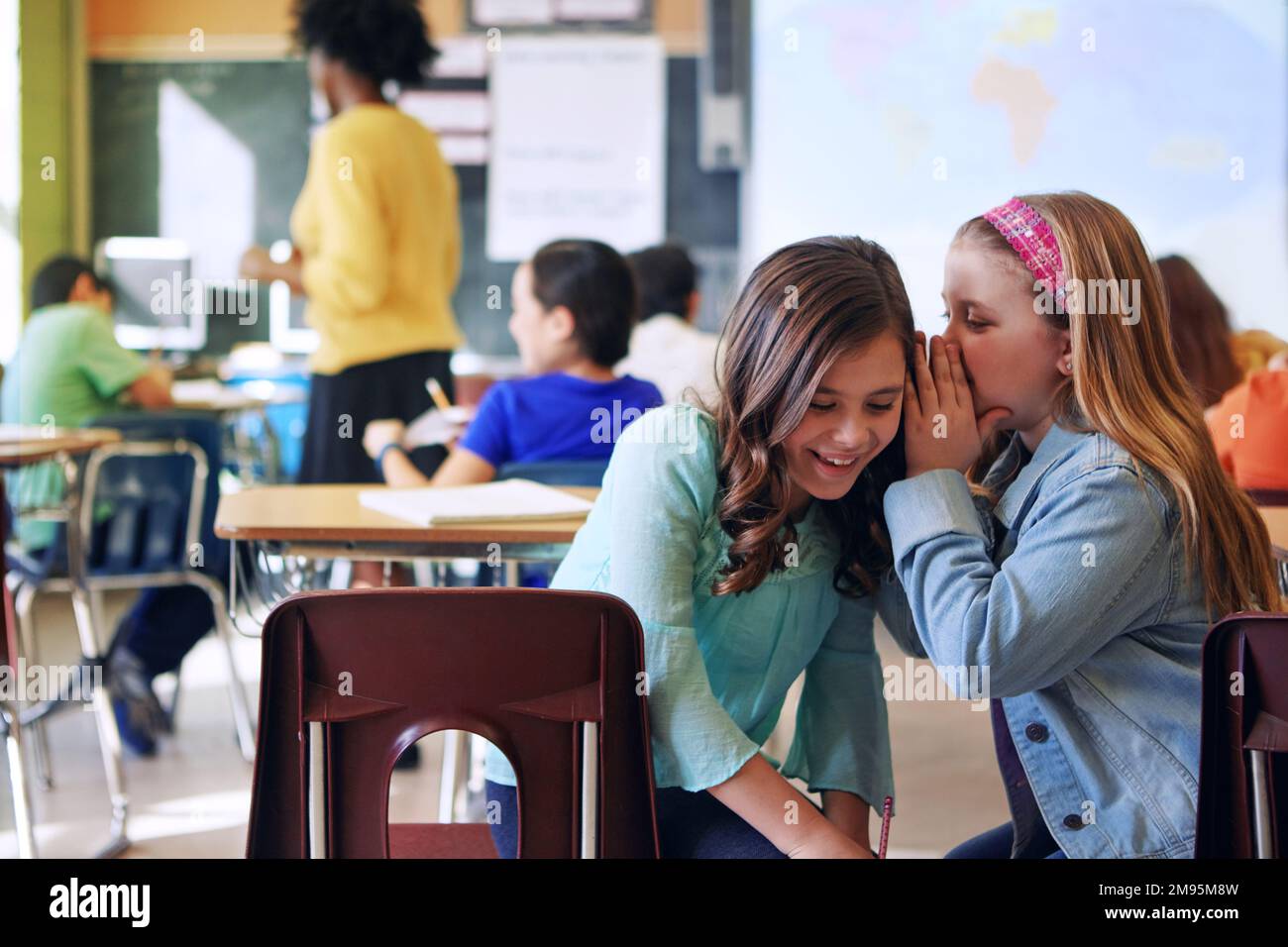 Friends, whisper and gossip in classroom for secret, talking or ...
