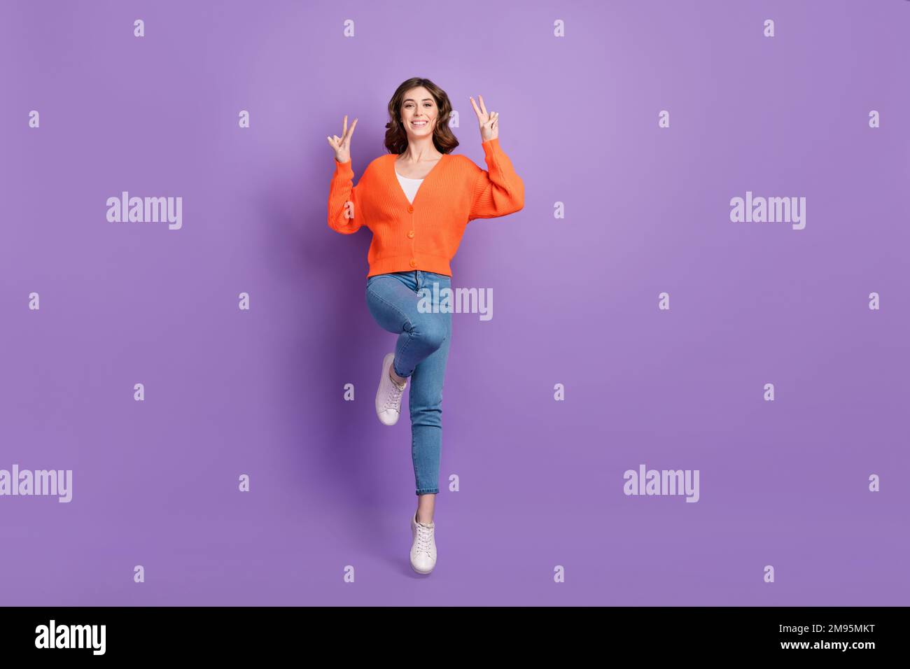 Full length photo of excited friendly lady wear orange cardigan jumping ...