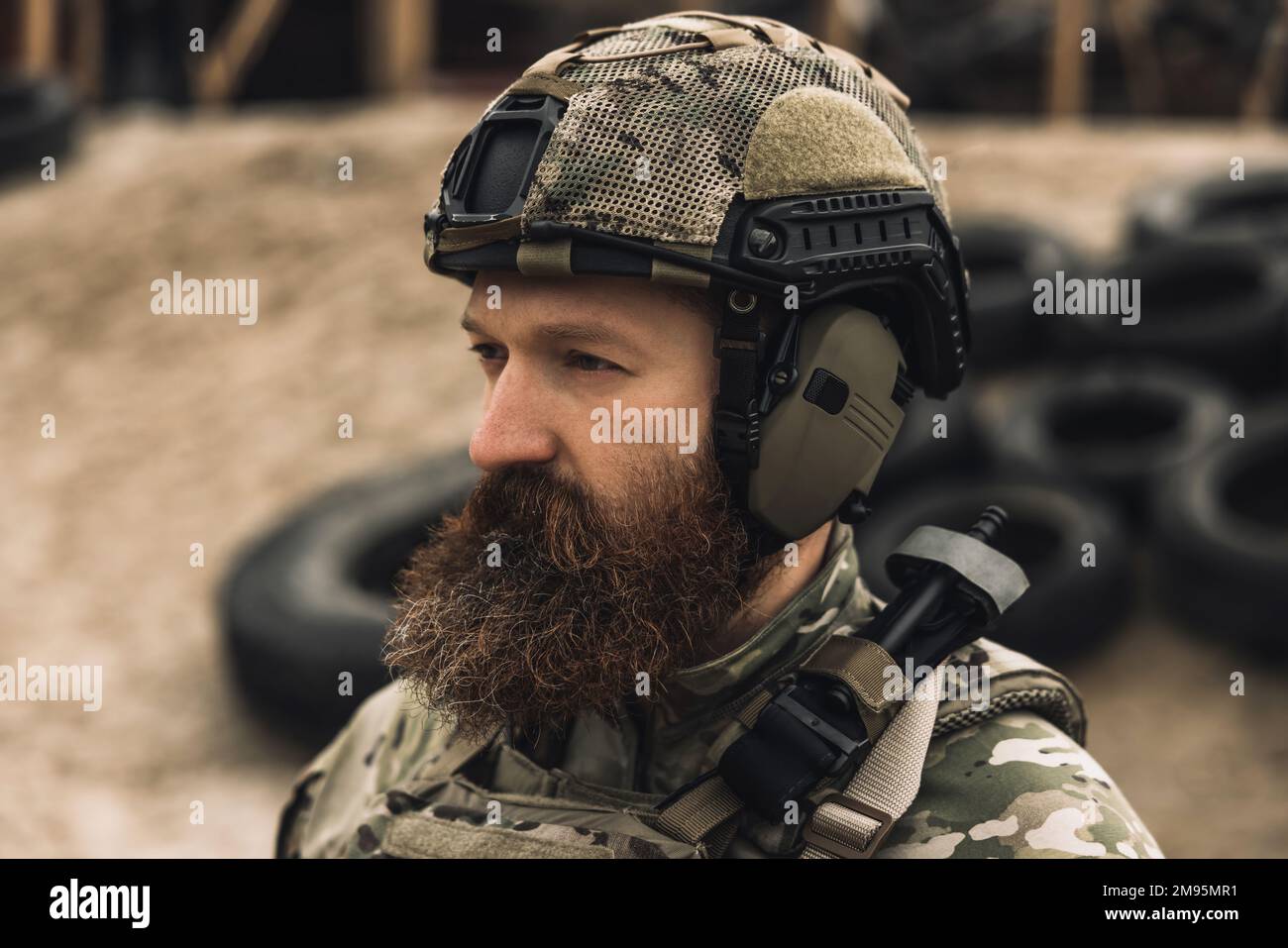 Bearded soldier in military uniform looking determined and serious ...