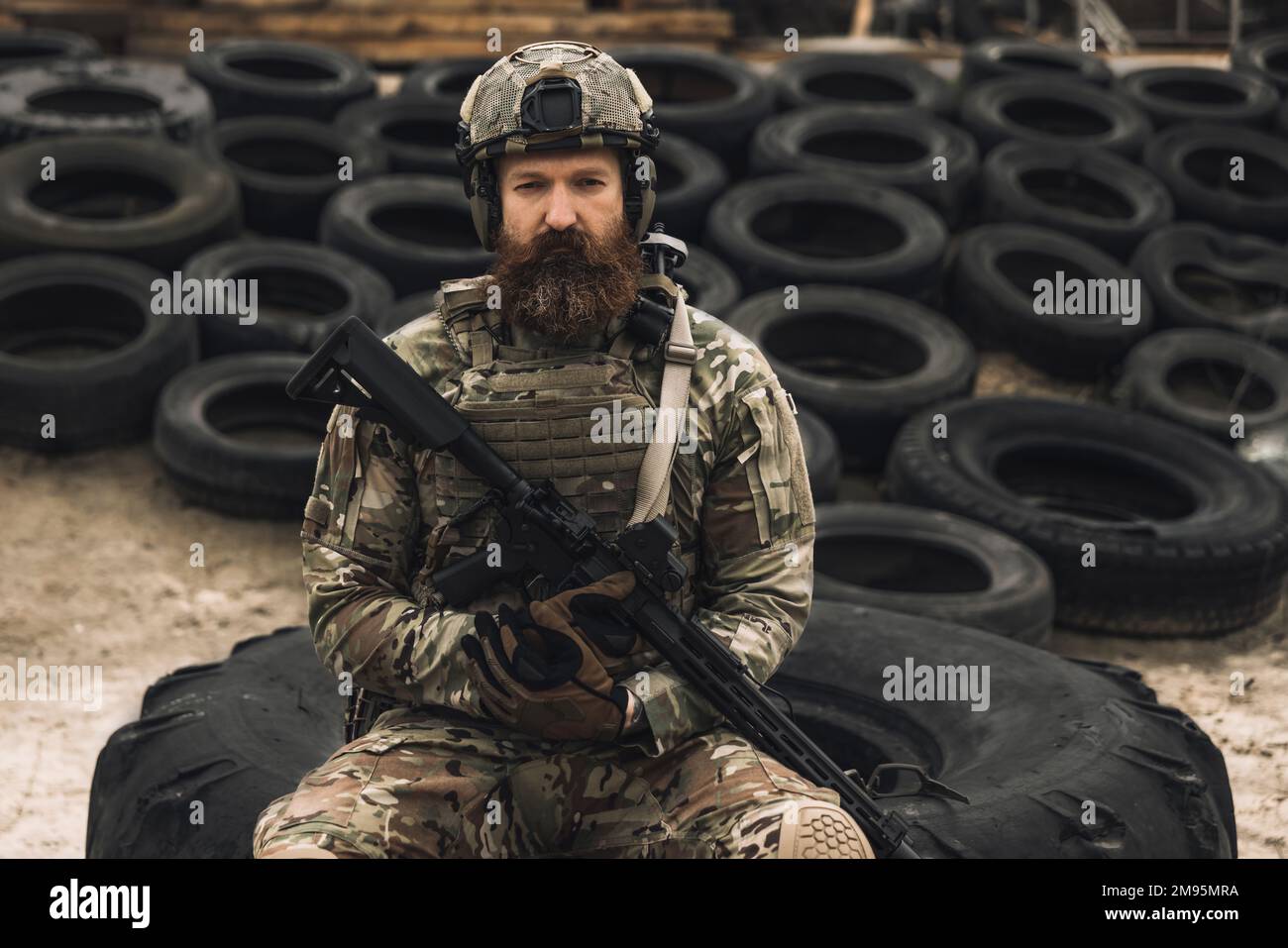 Bearded soldier in military uniform looking determined and serious ...