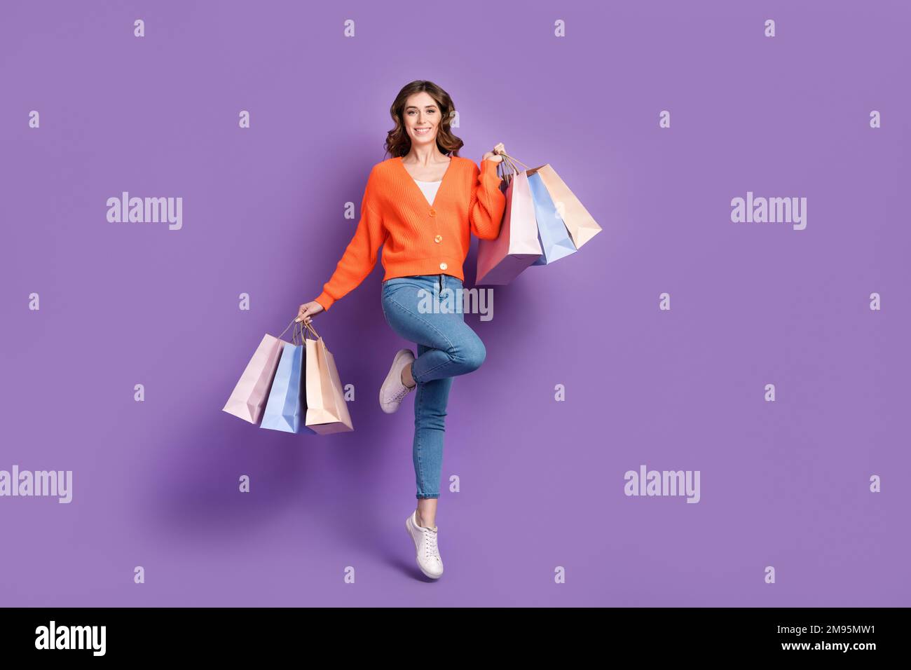 Full length photo of pretty shiny woman dressed orange rising bargains ...