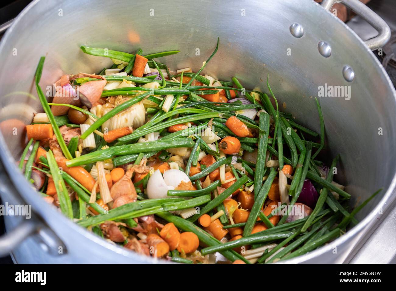 Preparing and cooking food: vegetables simmering in a cooking pot Stock ...