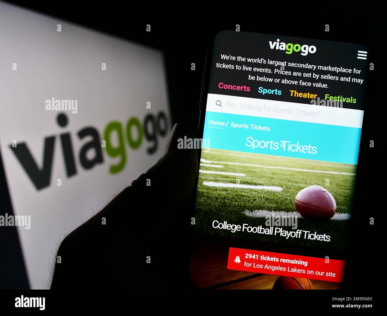 Person holding cellphone with webpage of US ticket exchange platform ...
