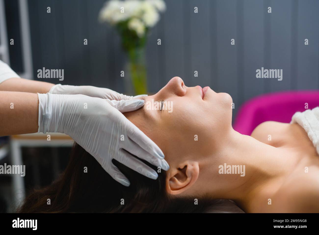 Beauty massage treatment to forehead skin, cosmetologist take care of ...