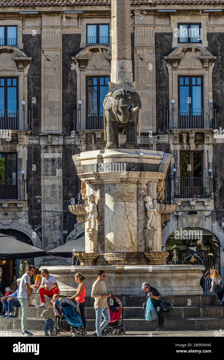 Tourists sitting on the steps of the elephant obelisk, symbol of the ...